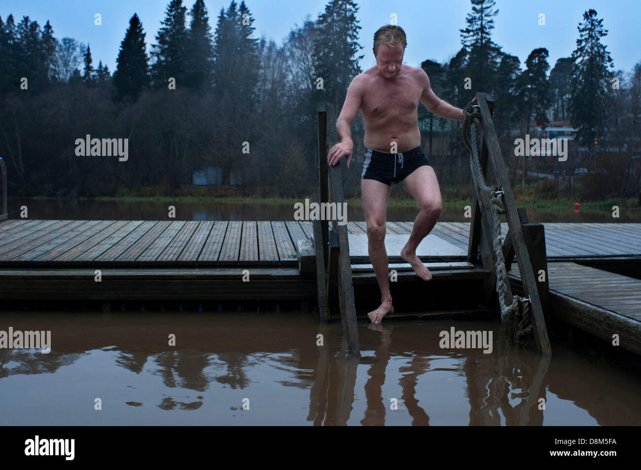 A man cools outside private Sauna Pikkukoski the north of the city of ...