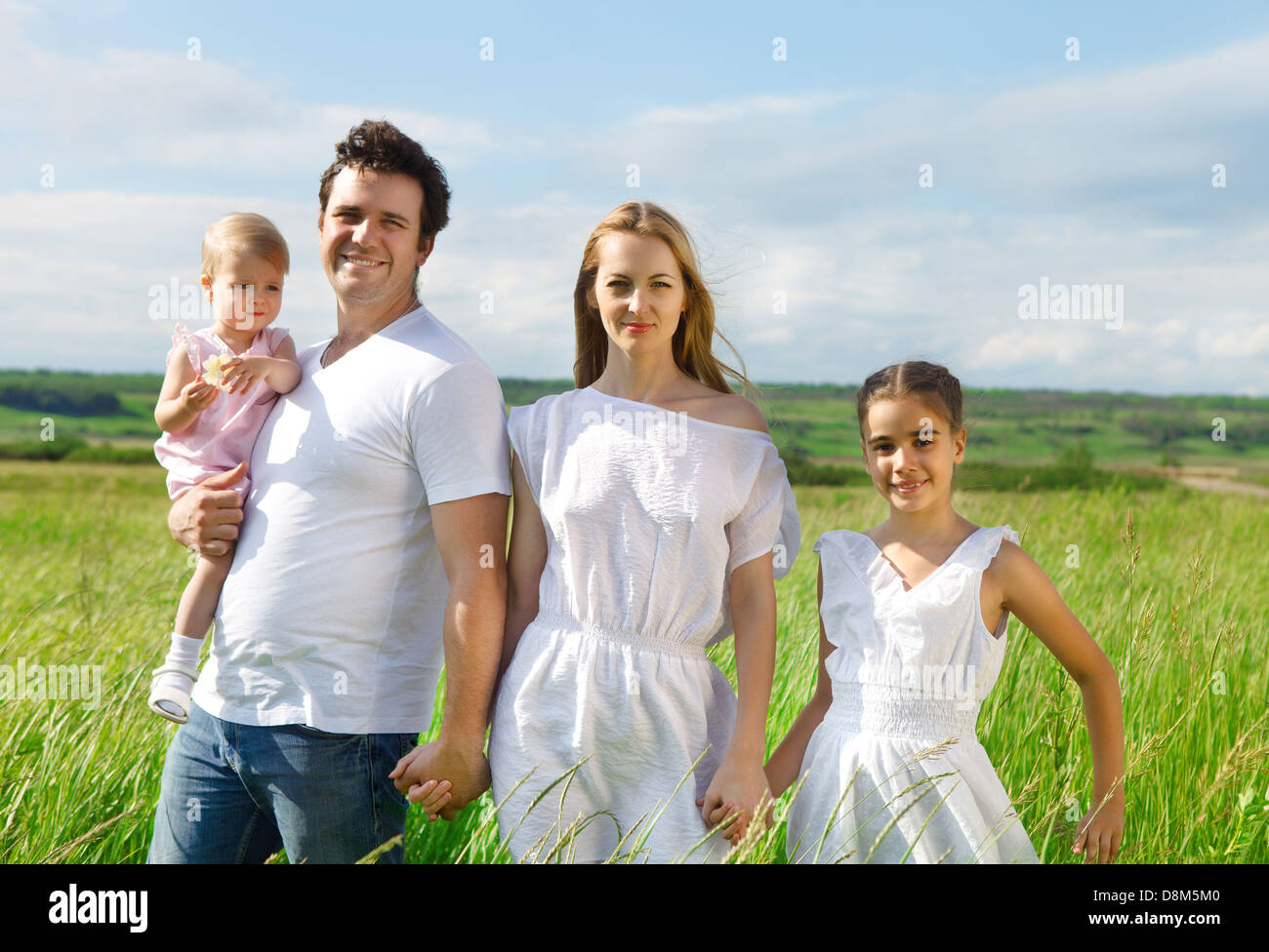 Happy young family outdoors Stock Photo - Alamy