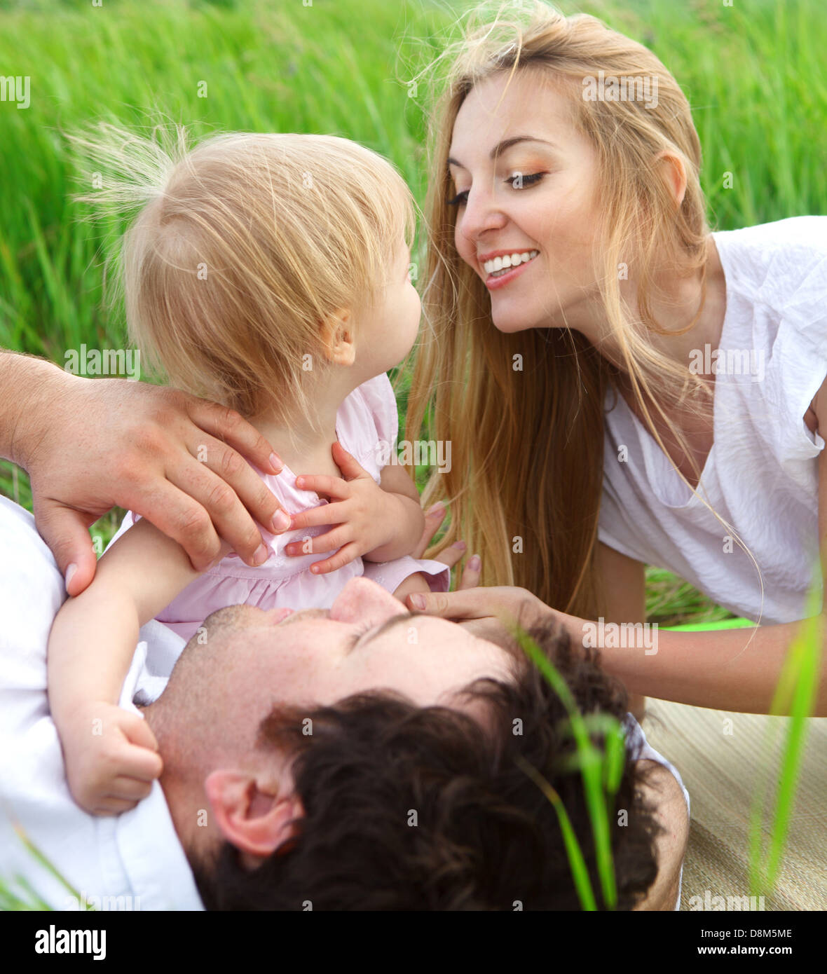 Happy young family outdoors Stock Photo - Alamy