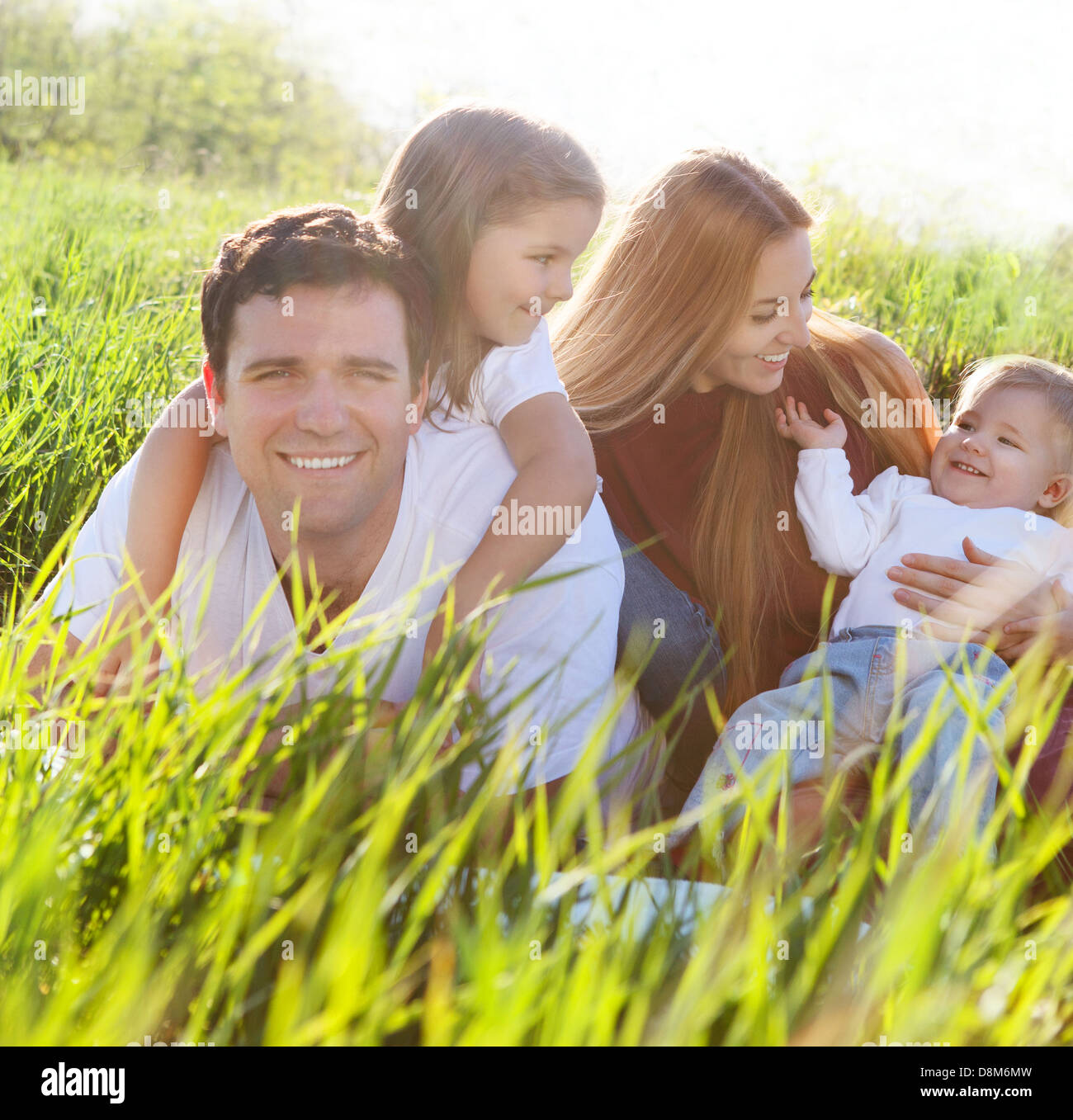 Happy young family with two children Stock Photo - Alamy