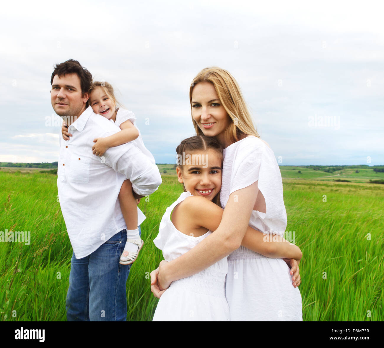 Happy young family outdoors Stock Photo - Alamy