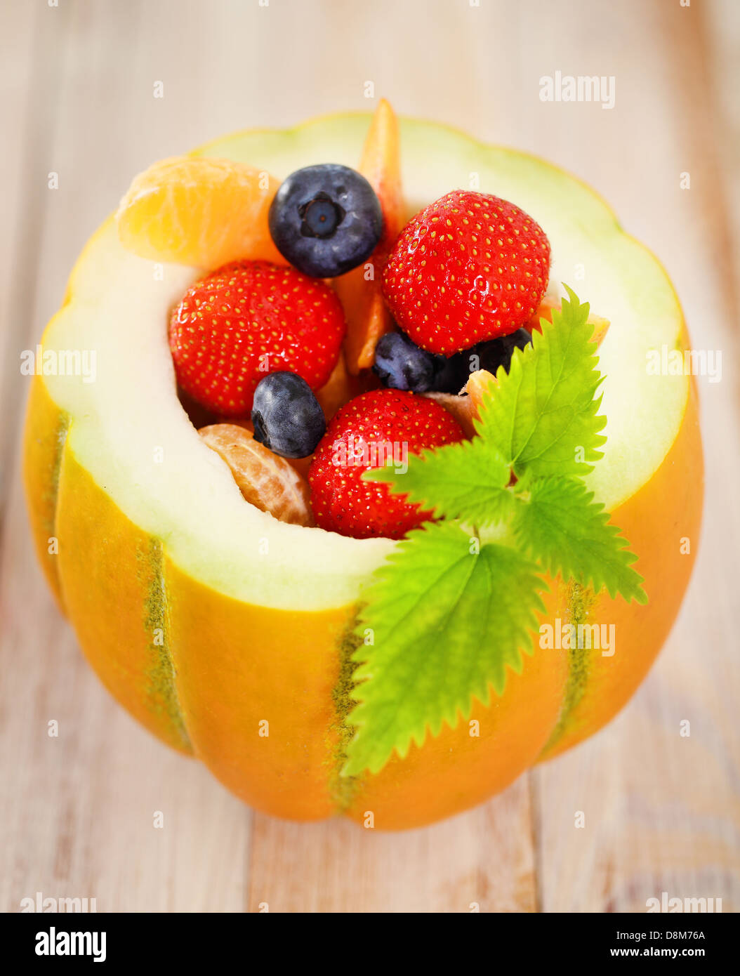 Delicious fresh fruits served in melon Stock Photo - Alamy