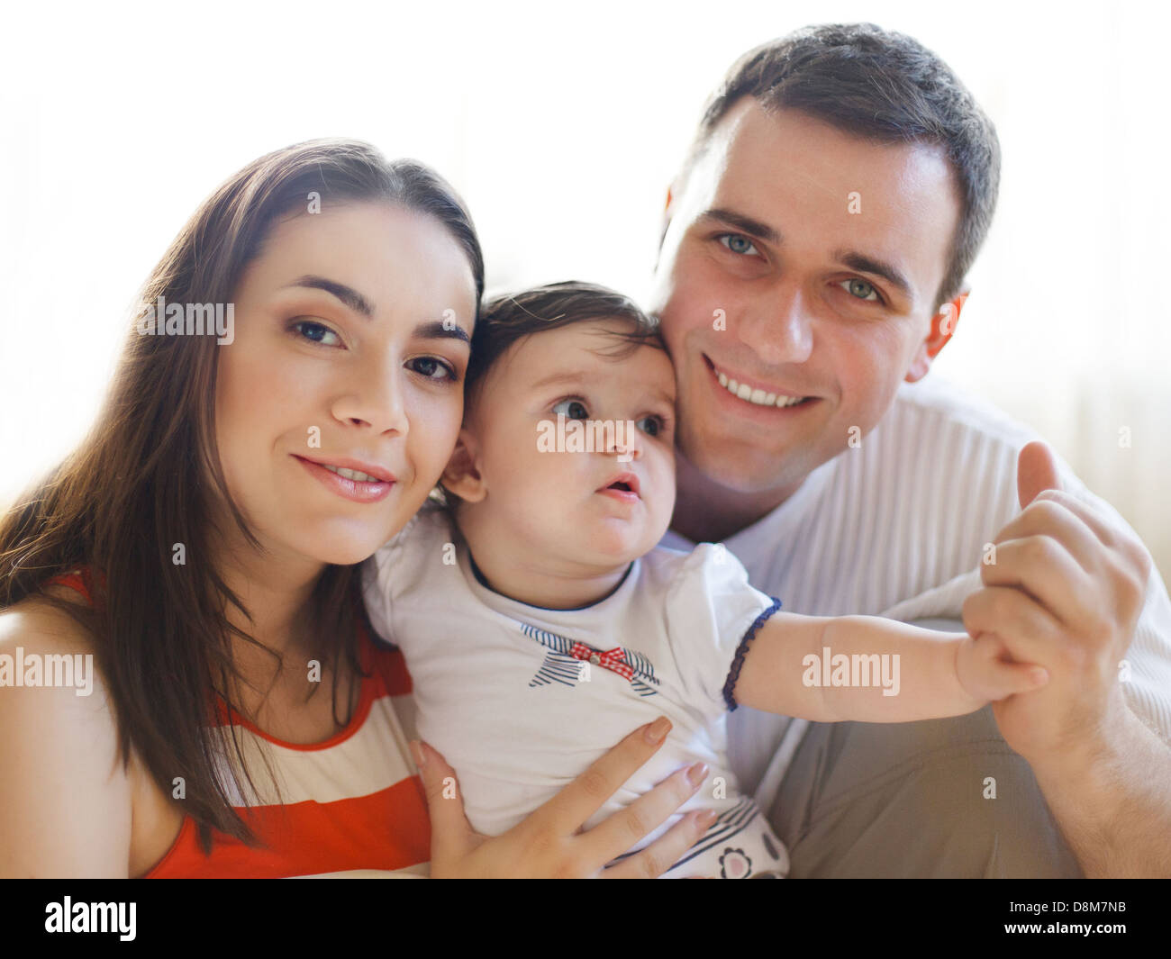 Happy young family with baby girl Stock Photo - Alamy