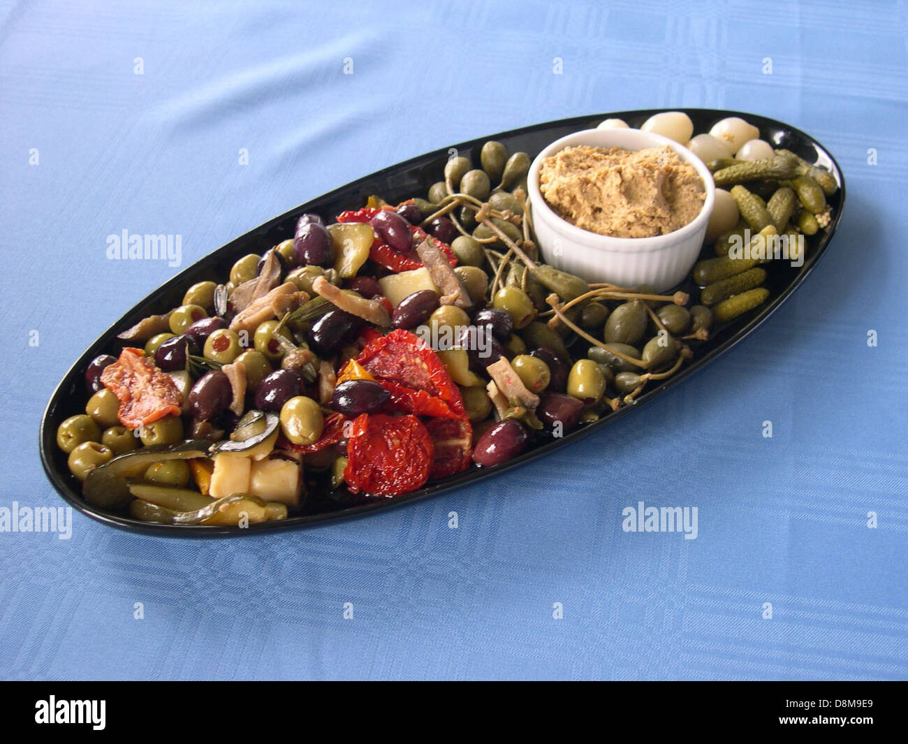 A meal served on an elegant oval plate, showcasing a well-arranged dish ...