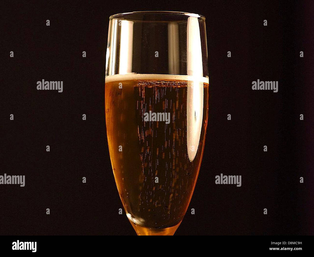 A close-up image shows beer glasses filled with bubbles, the ...