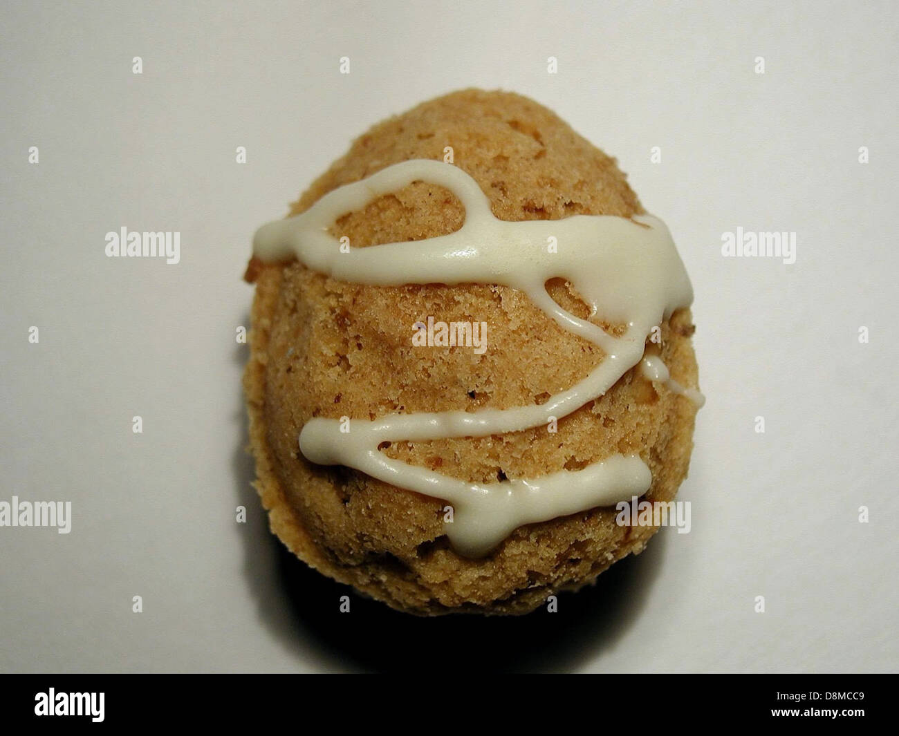 A single biscuit placed on a clean white background, emphasizing the ...