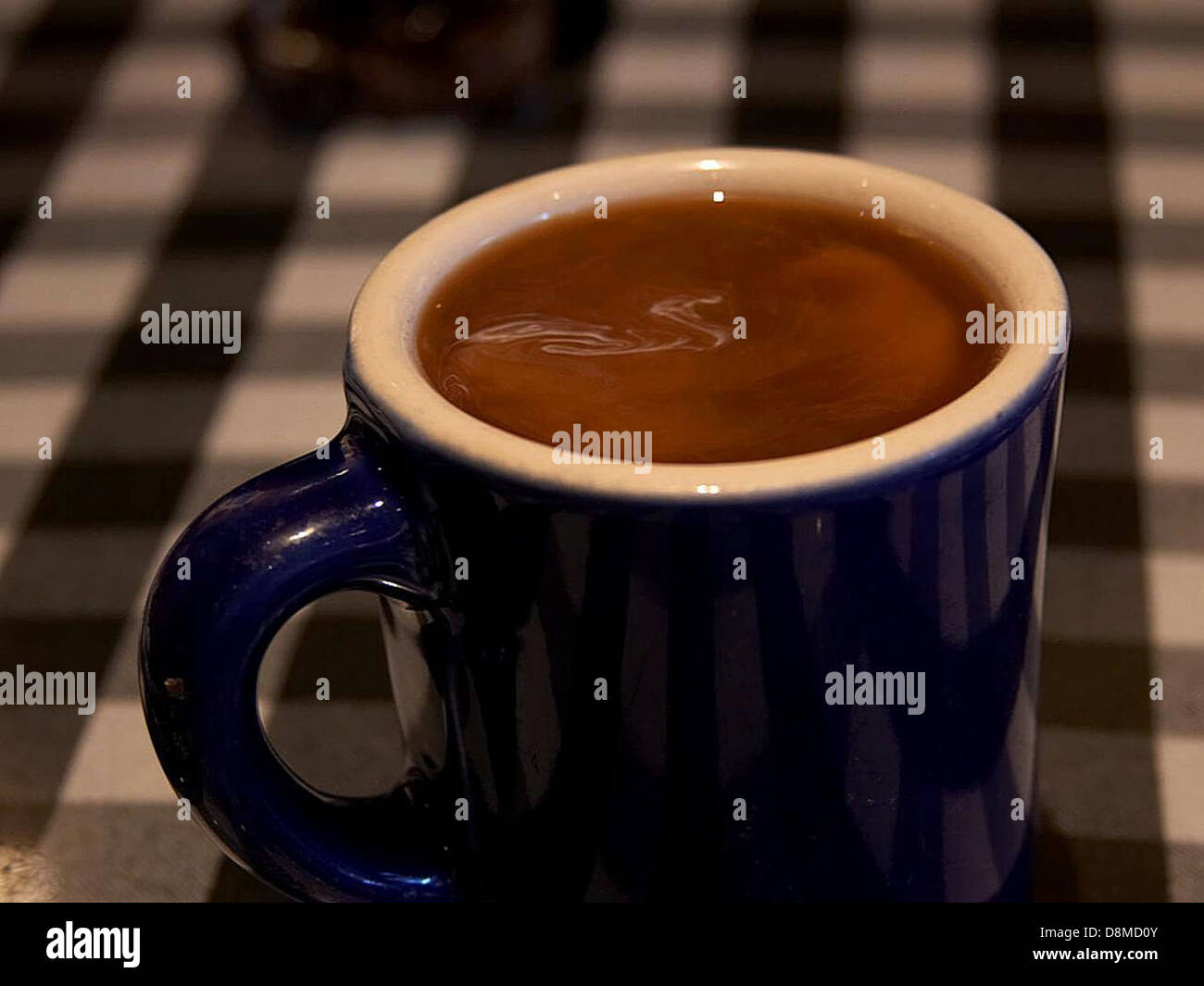 A simple coffee cup filled with freshly brewed coffee, emphasizing the ...