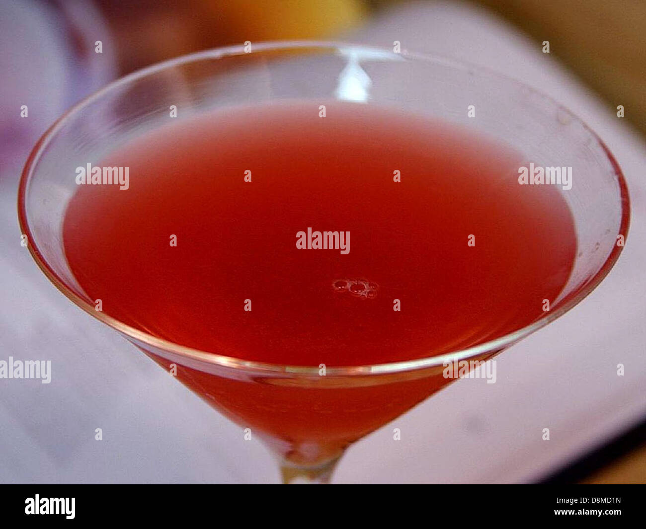 This image shows a Cosmopolitan cocktail, a classic drink made with ...