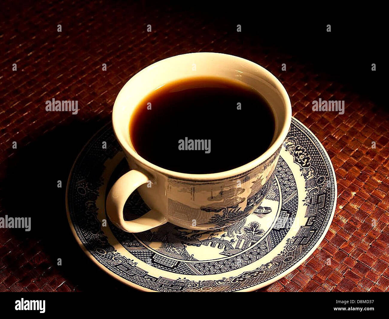 A steaming cup of coffee, with the dark liquid visible inside the cup ...