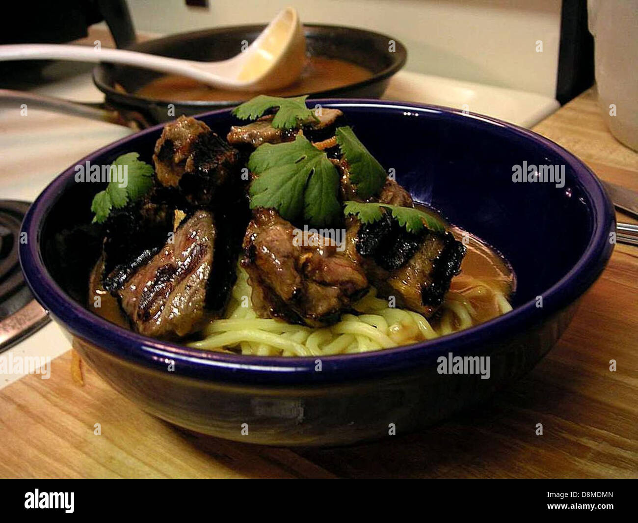 Grilling some tangerine marinated beef Stock Photo - Alamy