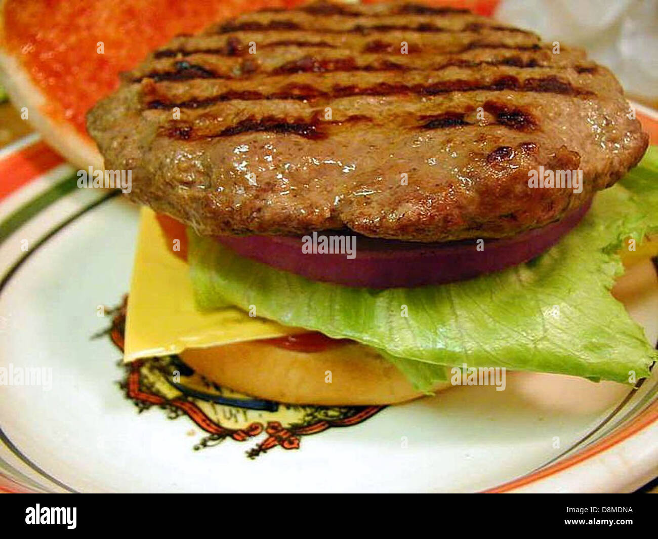 A classic hamburger featuring a juicy meat patty, fresh lettuce ...