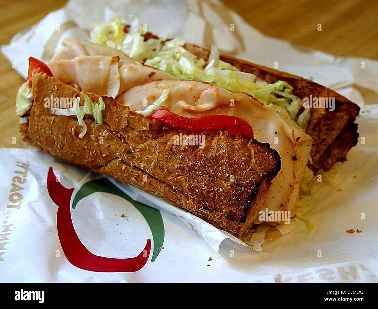 A Quiznos sub sandwich is shown with a variety of fillings, featuring ...