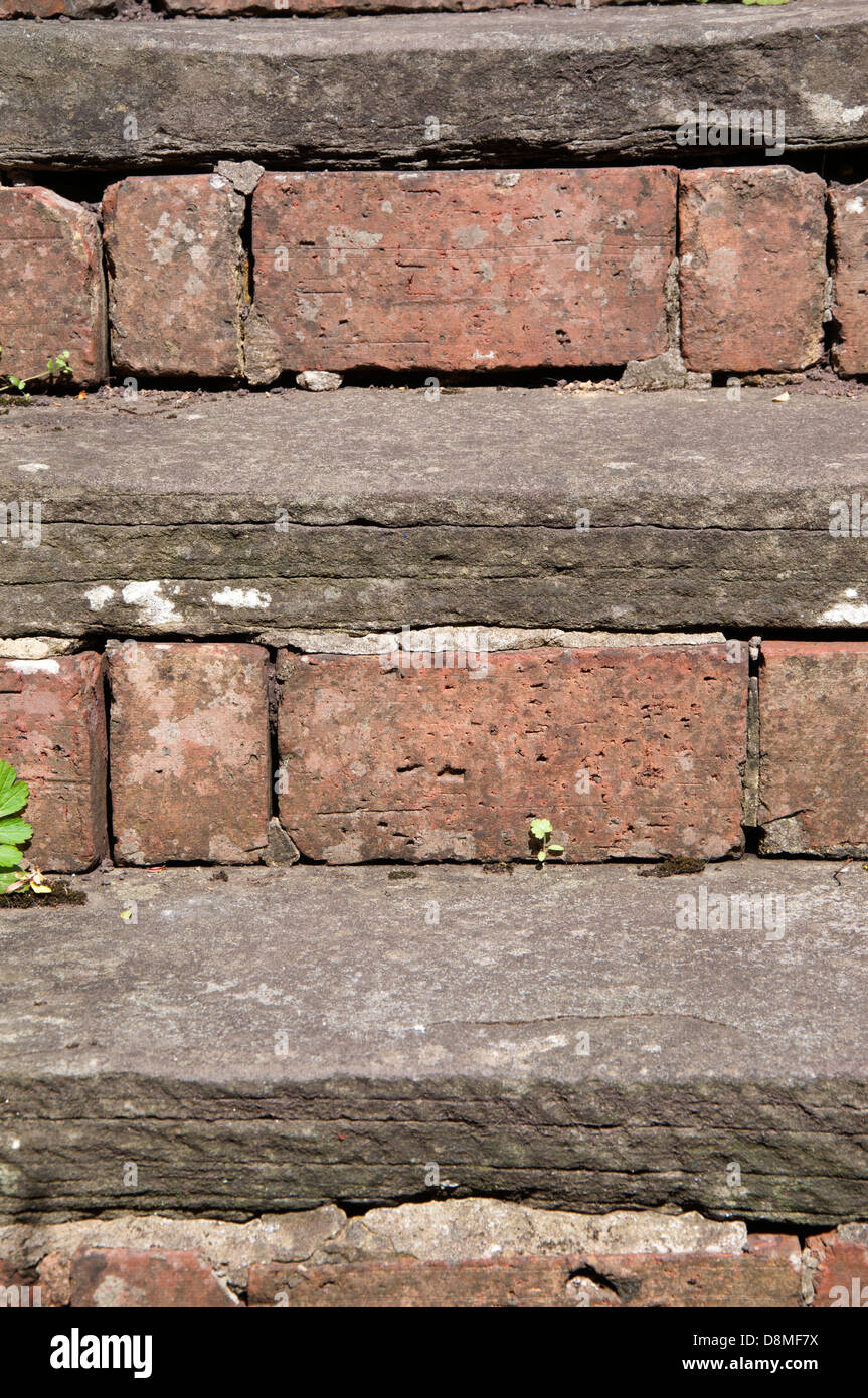 steps in stone and brick, old, worn, sunlit,natural stone steps with ...