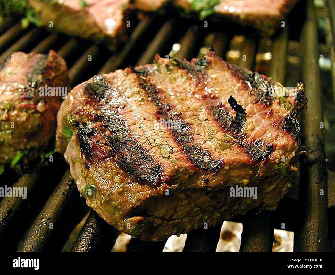 A sizzling steak being grilled on a barbecue, showcasing the delicious ...