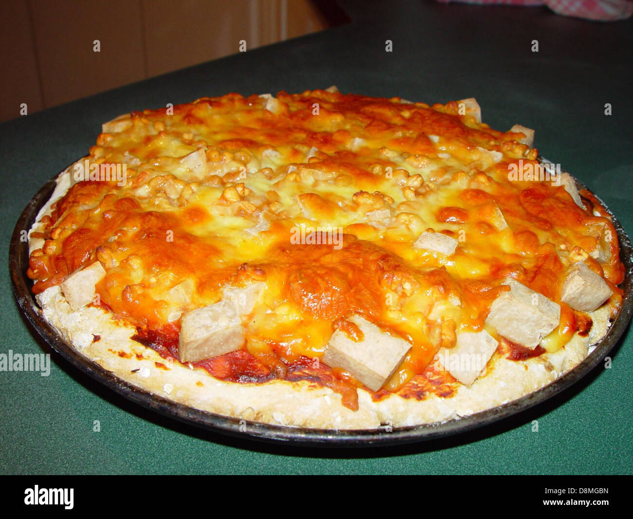 A vegetarian pizza topped with chunks of nutolene, beans, and melted ...