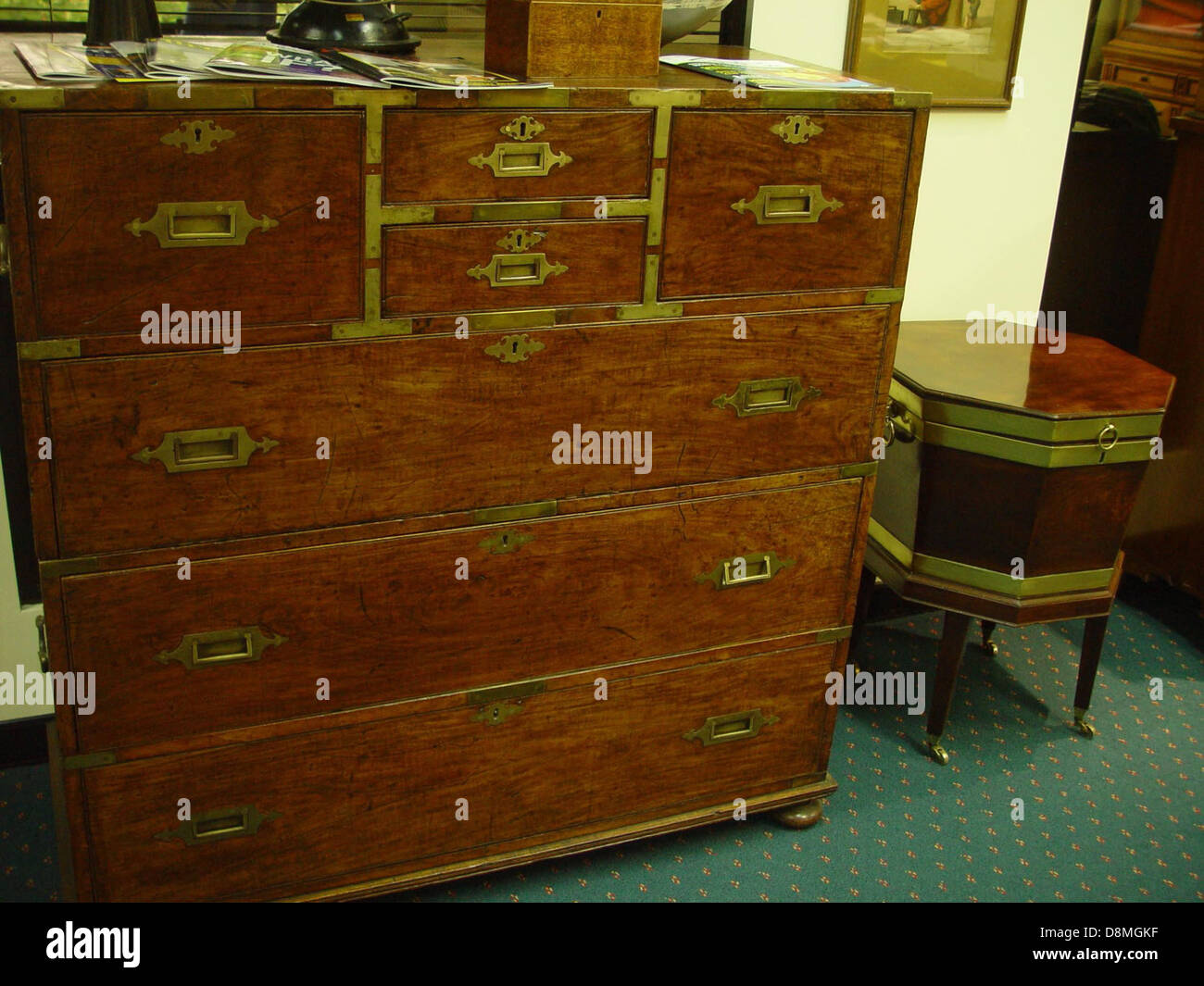 An antique chest of drawers paired with an octagonal table, showcasing ...