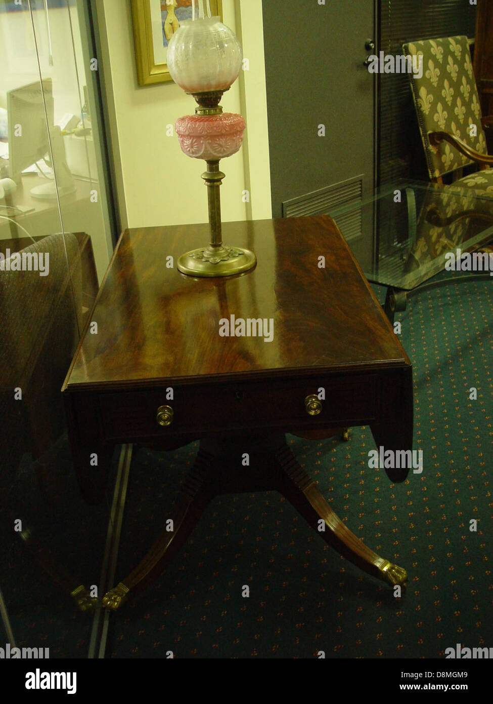 An antique table paired with a classic lamp, creating a vintage ...