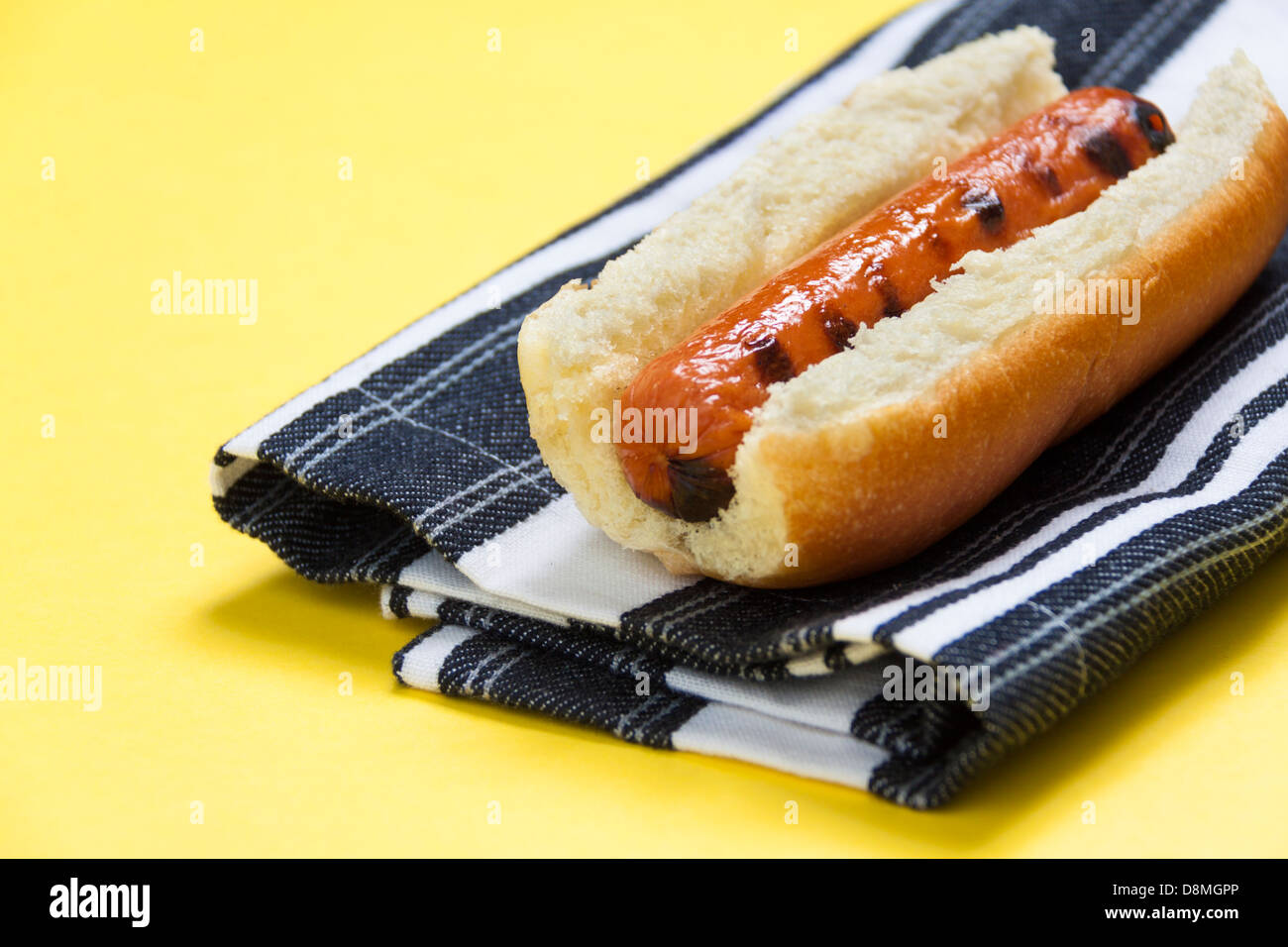 Grilled hot dog isolated on yellow background, horizontal Stock Photo ...