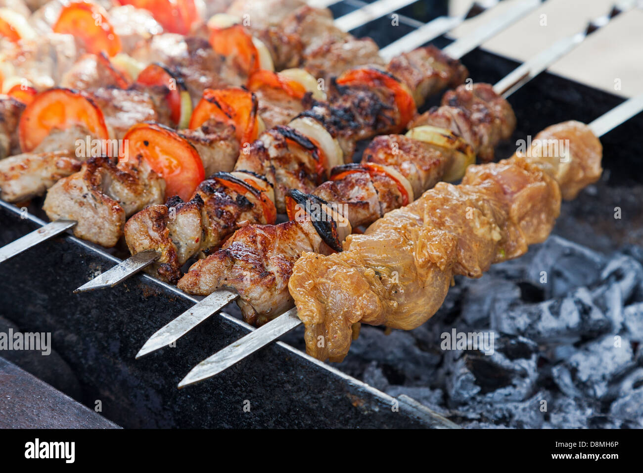 Appetizing fresh meat shish kebab (shashlik) prepared on a grill wood ...