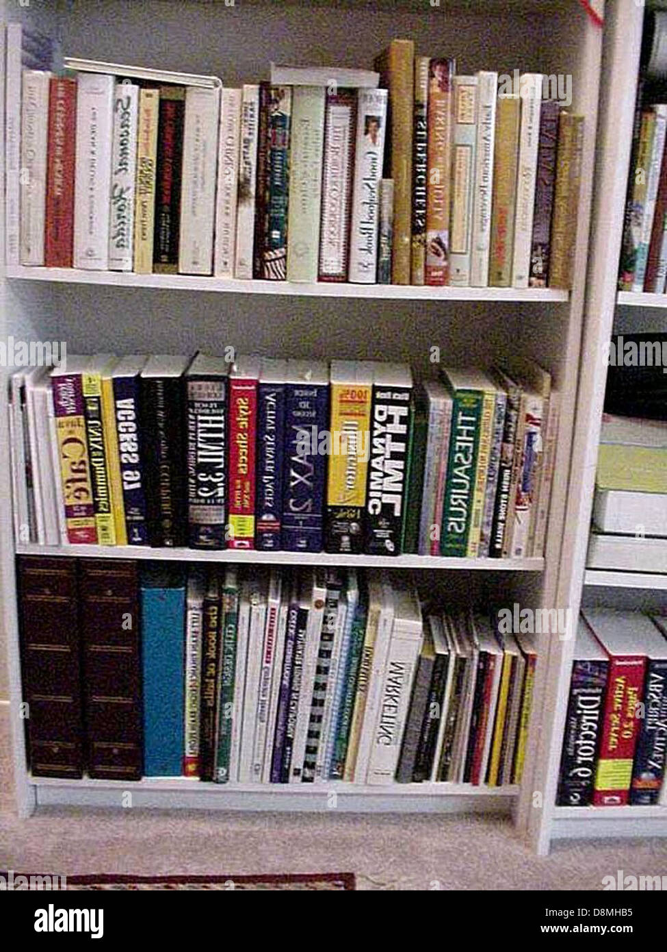A well-organized bookshelf filled with a variety of books, offering a ...