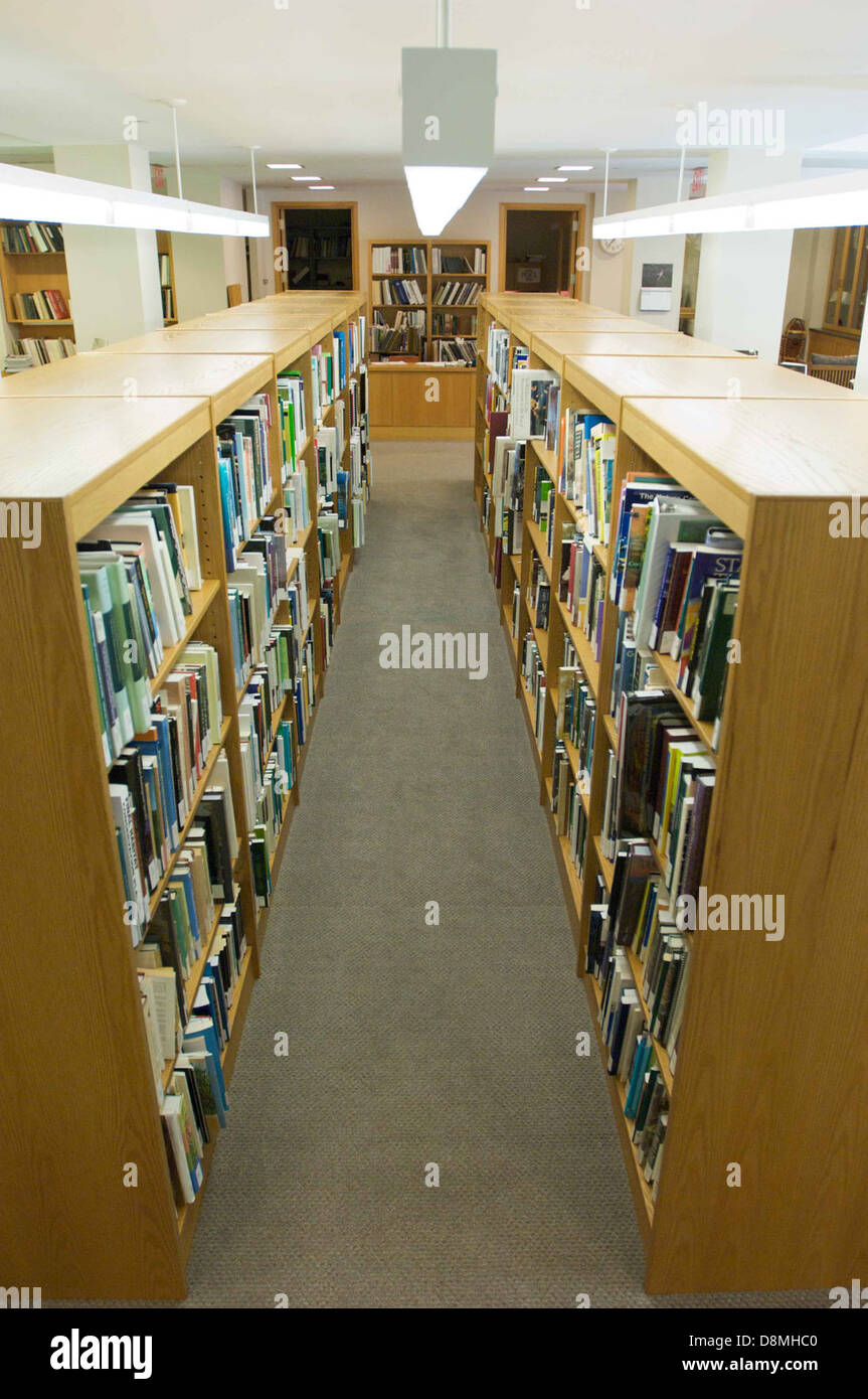 A photo of a library bookshelf filled with books, organized neatly on ...