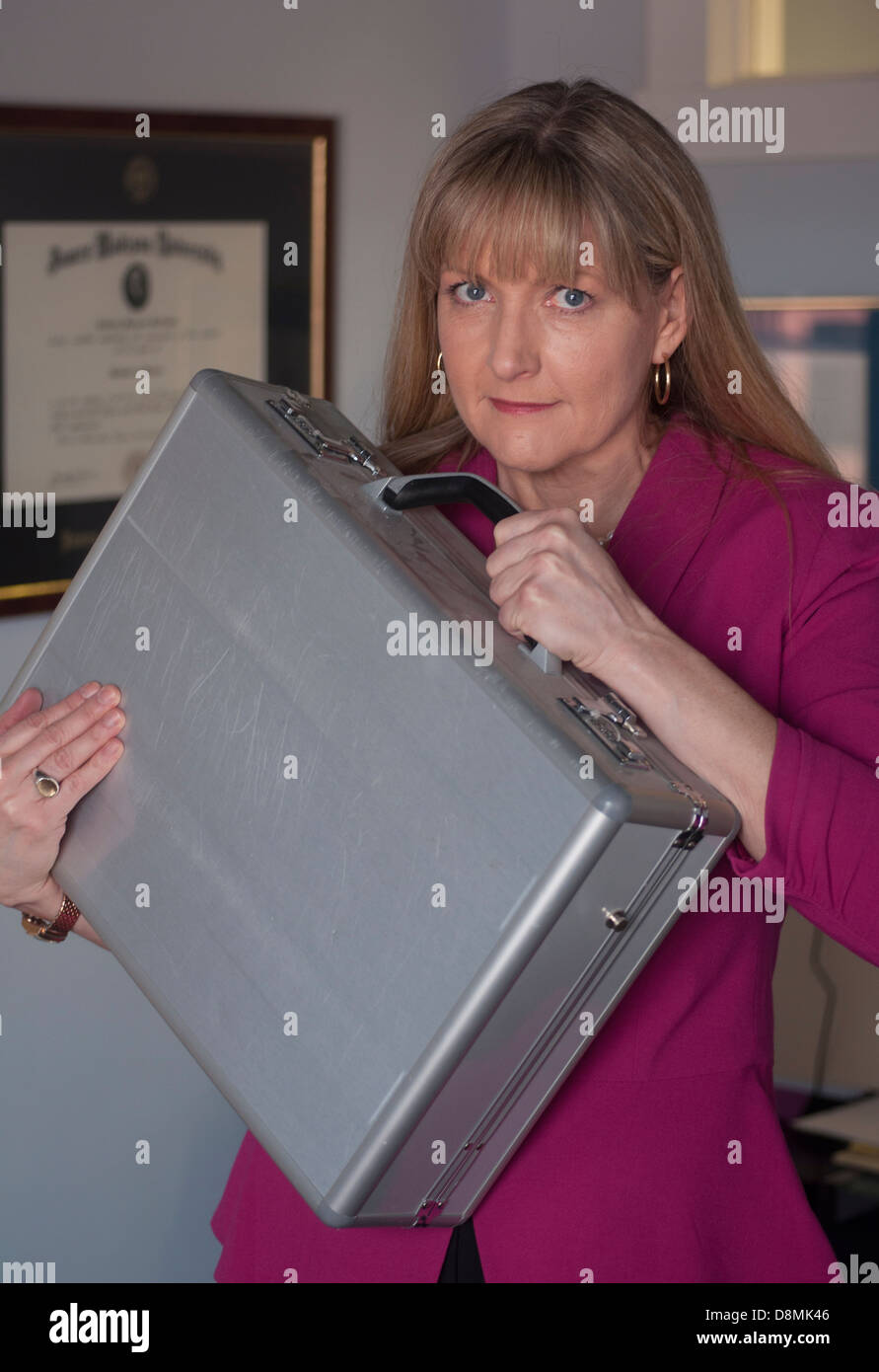 Woman holding metal briefcase Stock Photo - Alamy