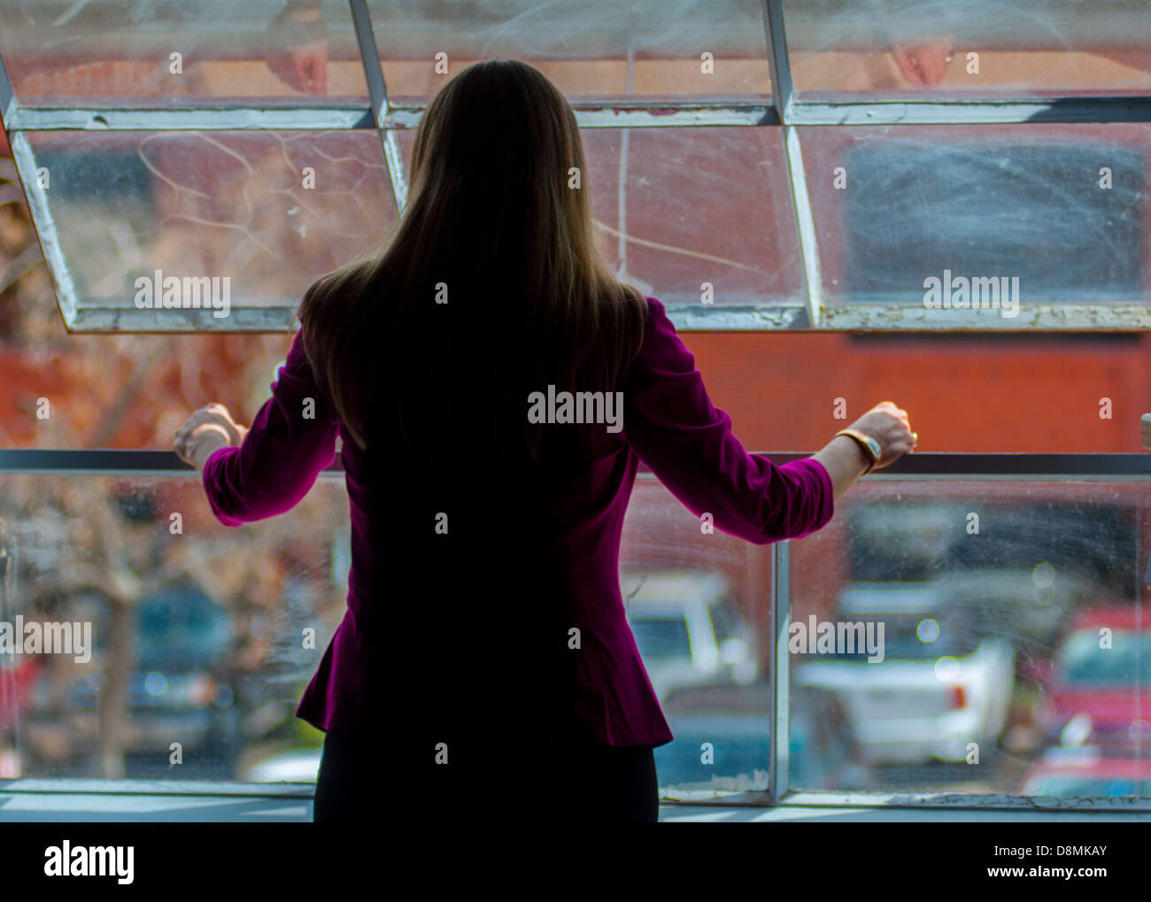 Woman standing at window Stock Photo - Alamy