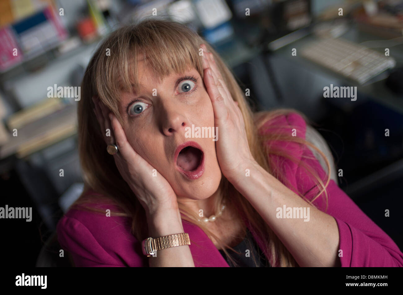 Woman with expression of panic Stock Photo - Alamy
