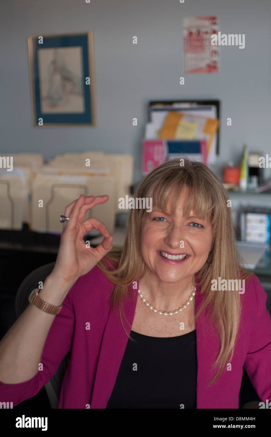 Woman giving 'okay' sign Stock Photo - Alamy