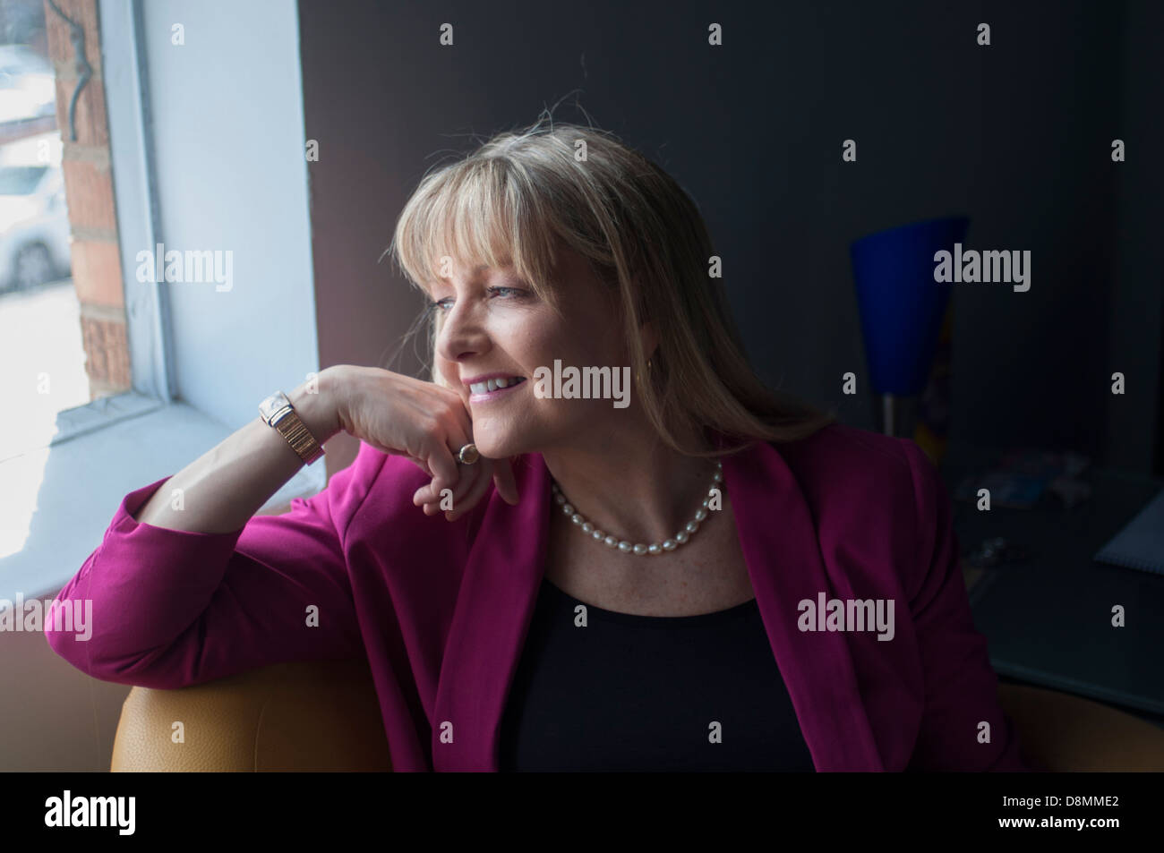 Woman gazing out window Stock Photo - Alamy