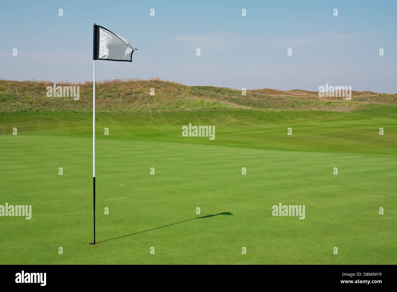 Golf ball in a green course and hole Stock Photo - Alamy