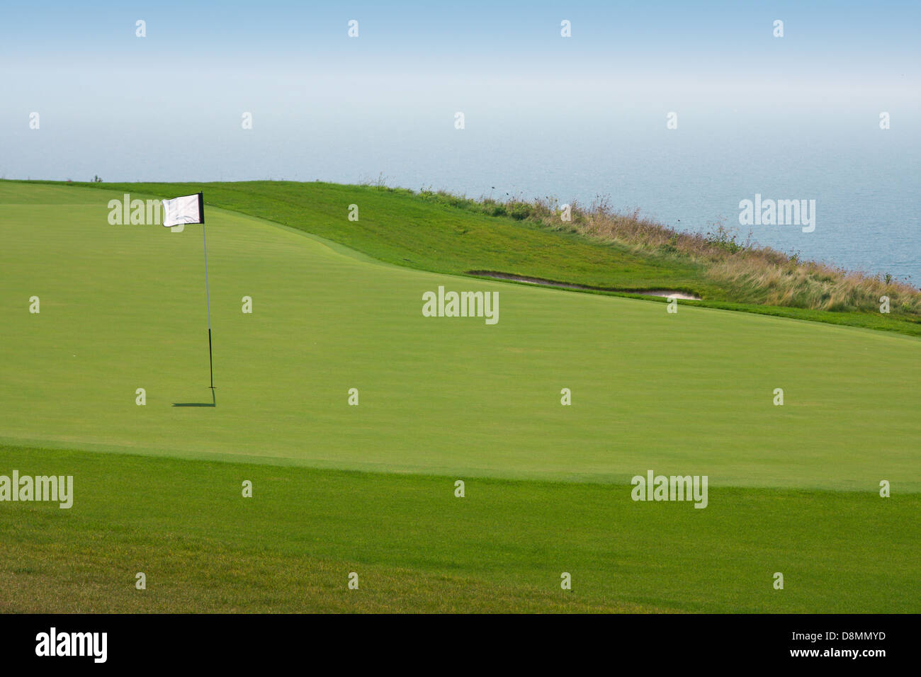 Golf ball in a green course and hole Stock Photo - Alamy