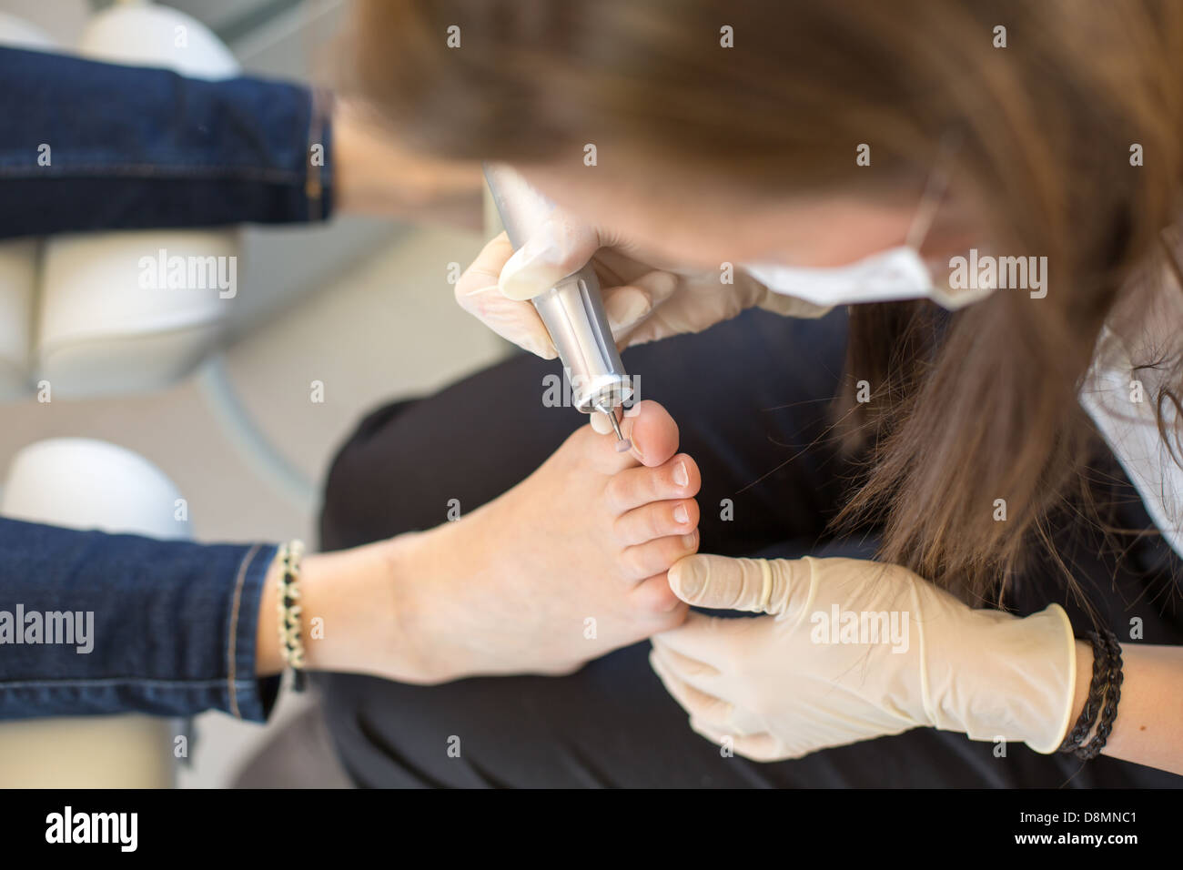 pedicure grinding toe nails of customer Stock Photo - Alamy