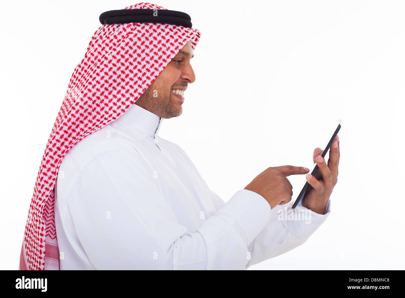 side view of cheerful arabian man using tablet computer on white ...