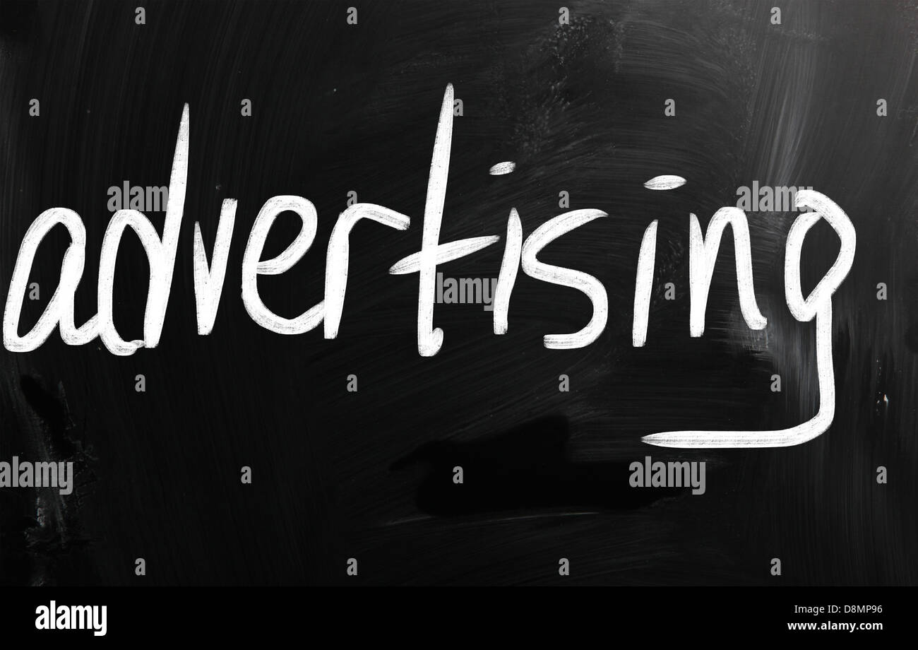 The word "advertising" handwritten with white chalk on a blackboard ...