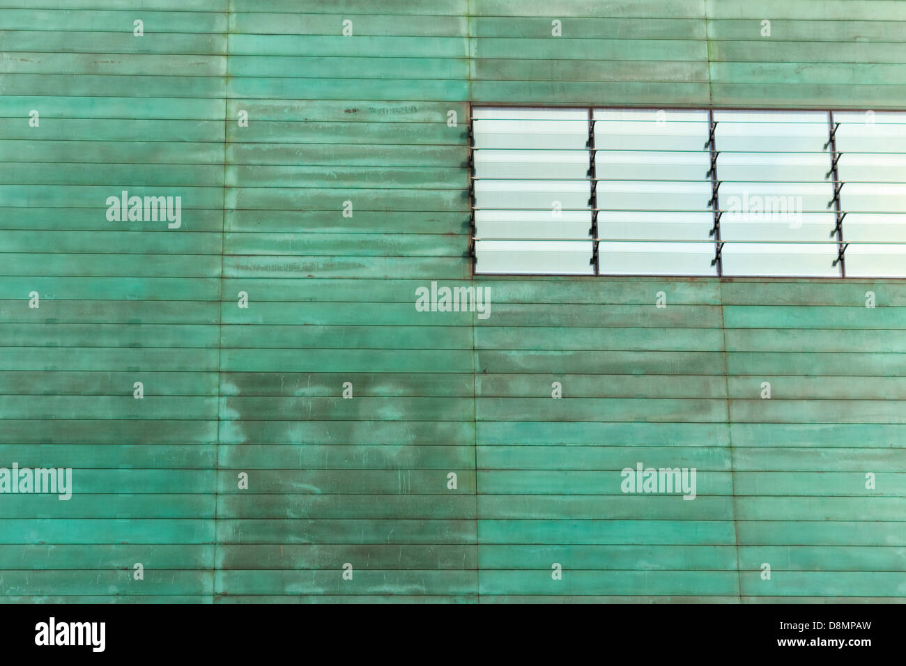 A green dirty old metal wall with a window Stock Photo - Alamy
