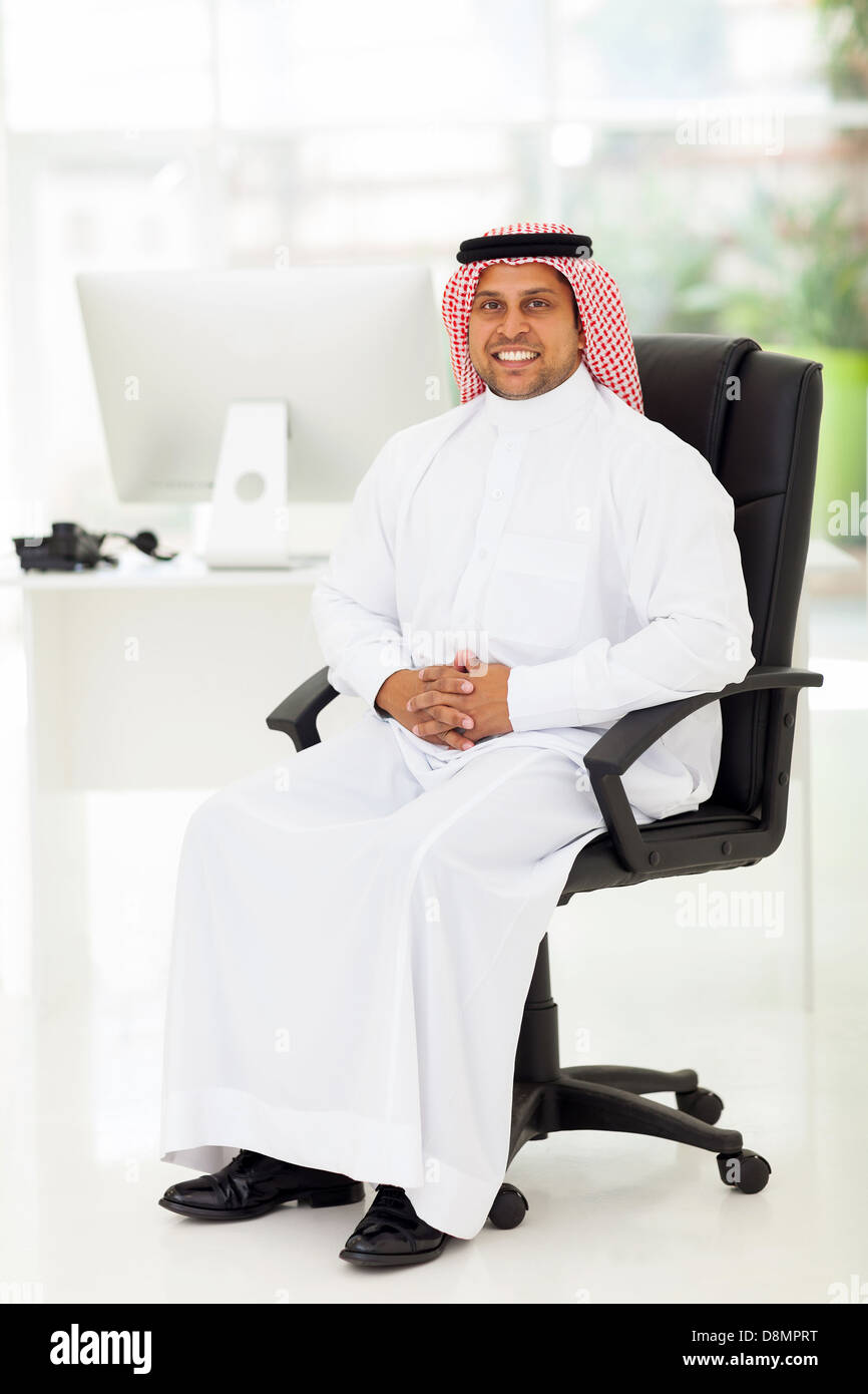 smiling middle eastern businessman sitting in modern office Stock Photo ...