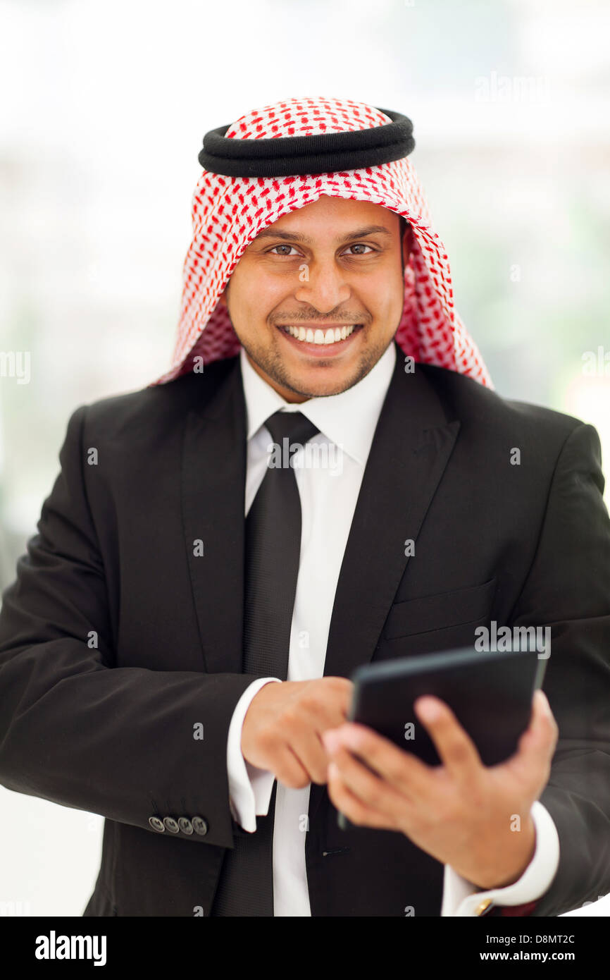 happy arab businessman browsing internet on his tablet computer Stock ...