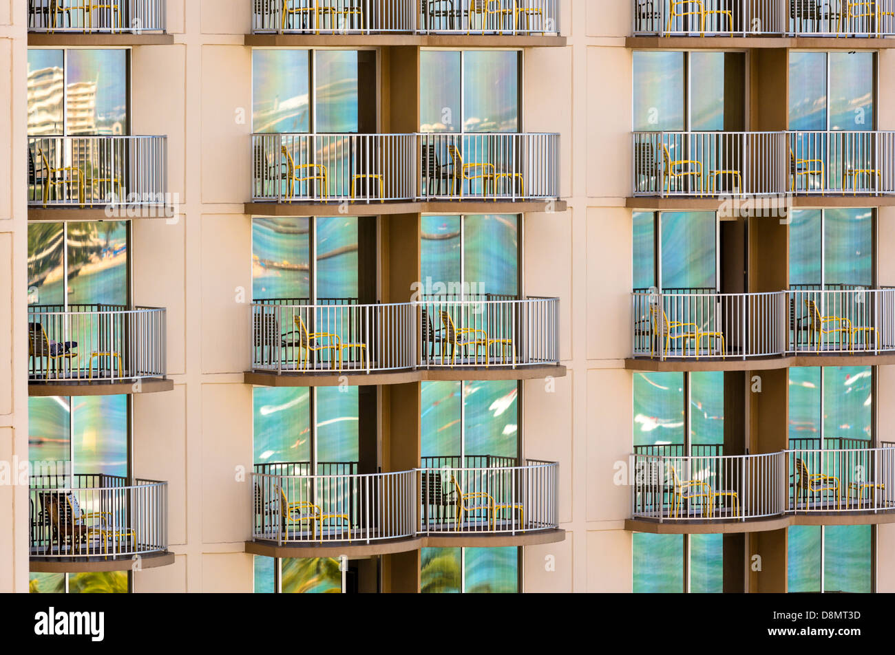 Waikiki beach reflected in the windows of a high rise hotel Stock Photo ...