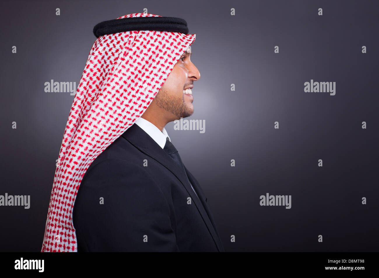 side view of smiling arabian man in black suit Stock Photo - Alamy