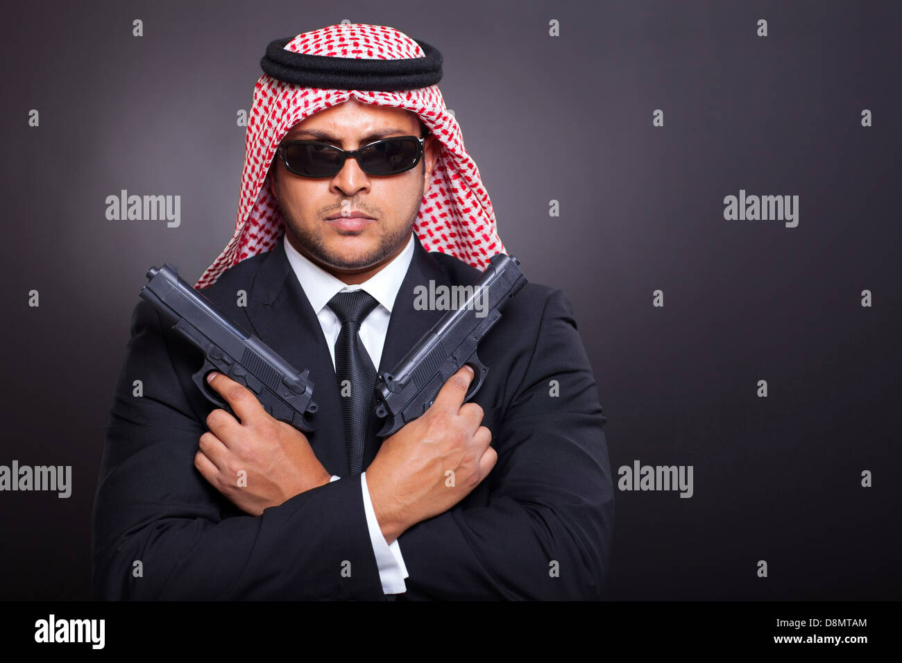 arabian mafia with two handguns on black Stock Photo - Alamy
