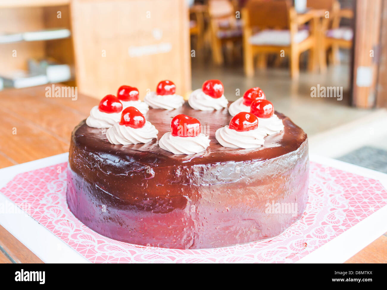 Chocolate cake with red cherry and whipped cream Stock Photo - Alamy