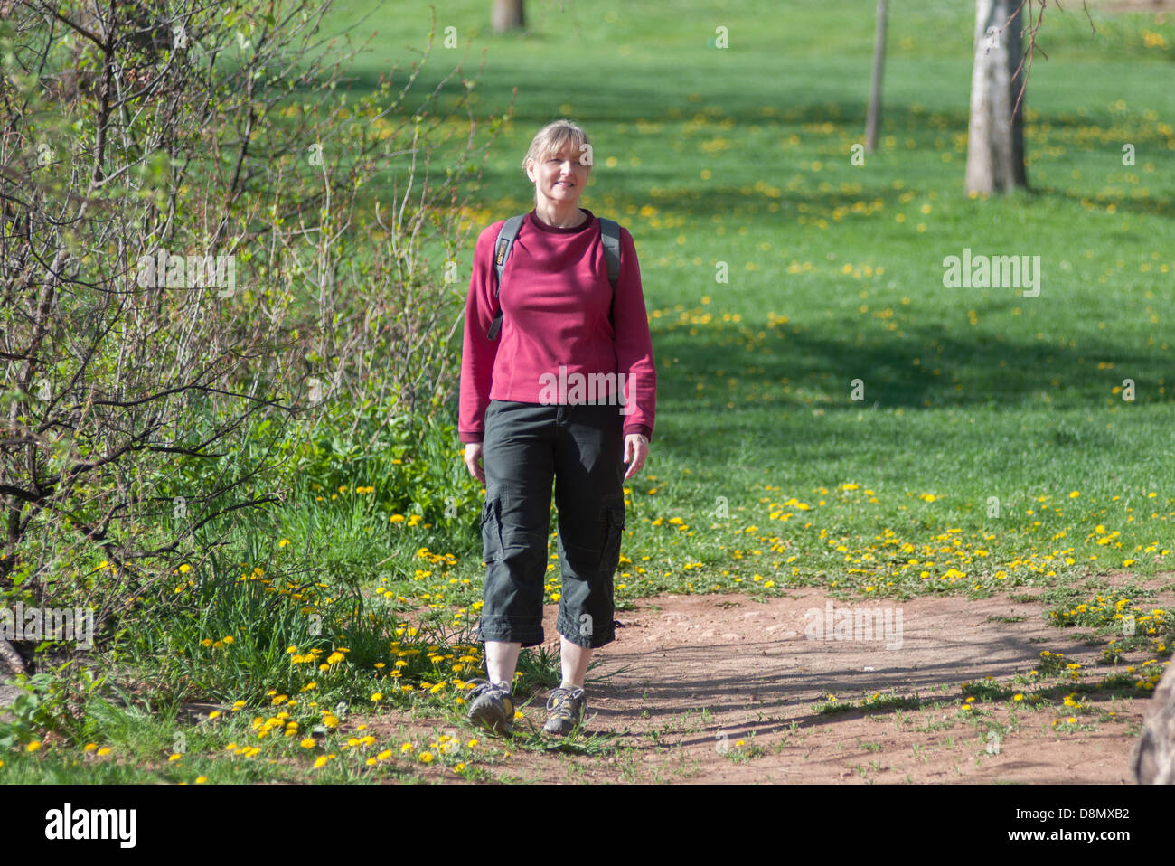 Woman walking on trail Stock Photo - Alamy