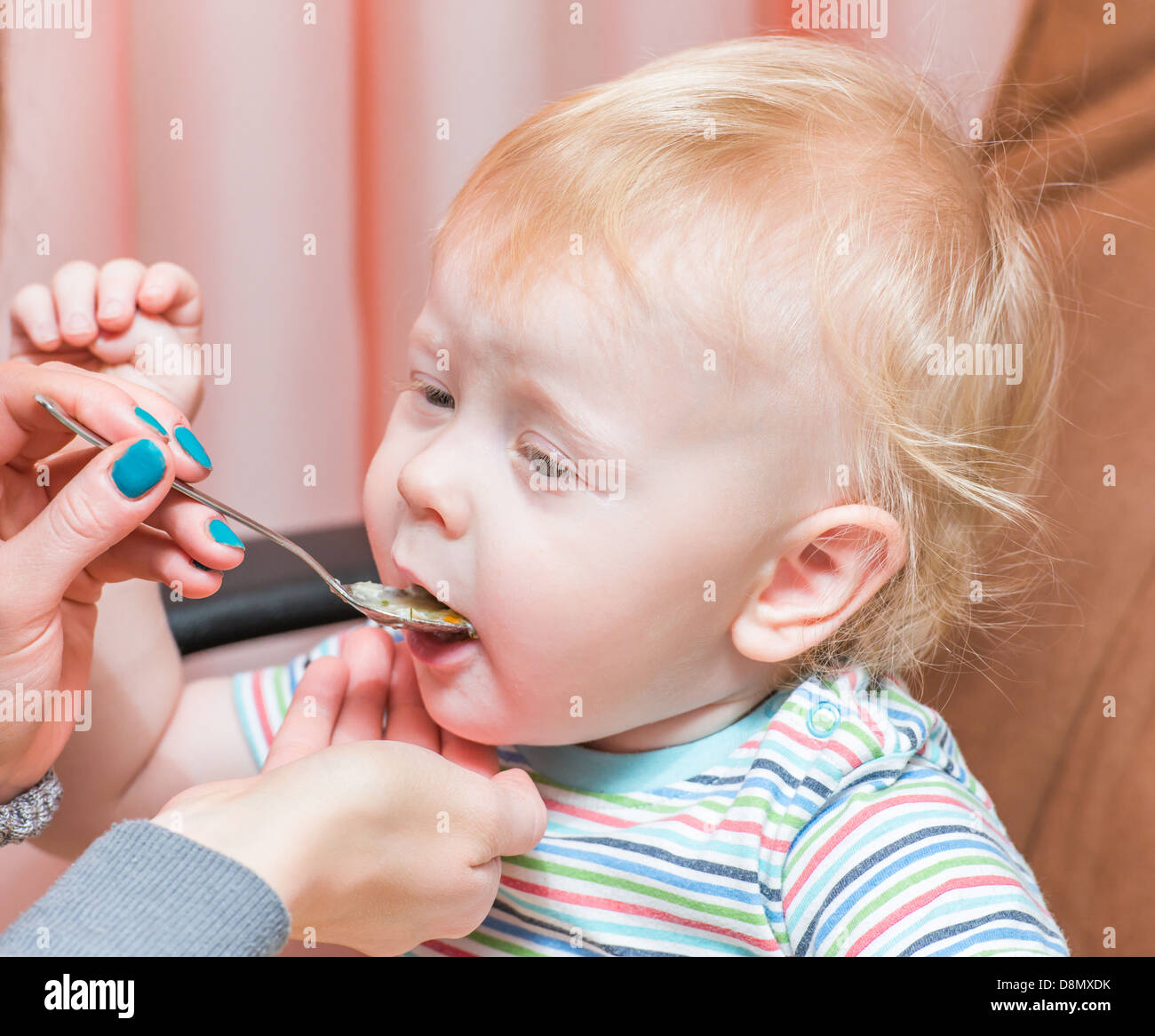 feeding a young child Stock Photo - Alamy