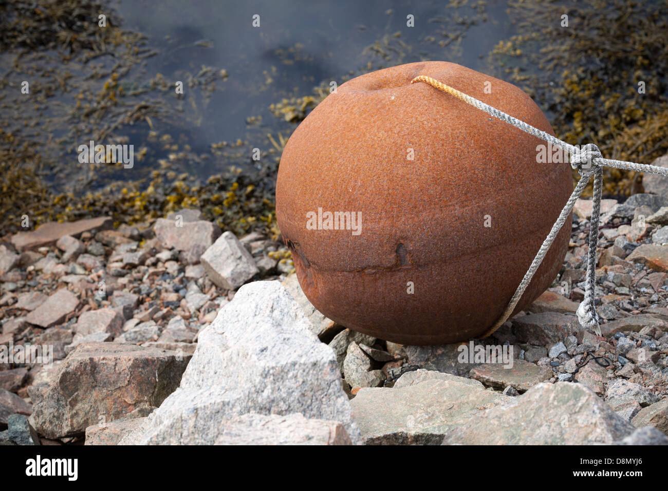 Rusted fishing sphere buoy lies on the seacoast Stock Photo - Alamy