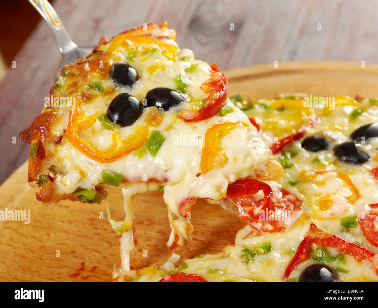 taking slice of pizza,melted cheese dripping Stock Photo - Alamy