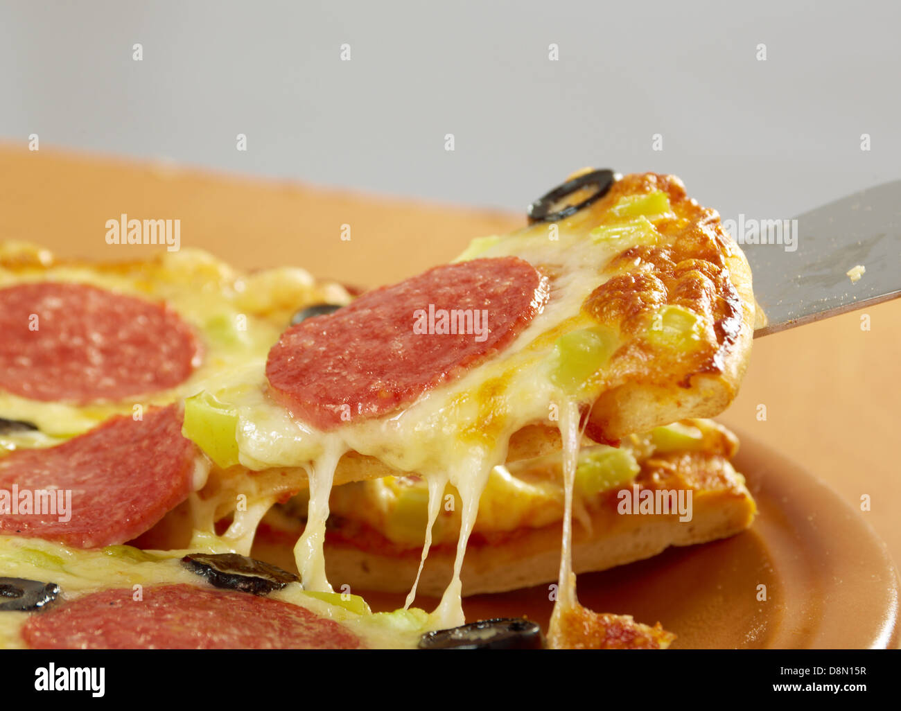 taking slice of pizza,melted cheese dripping Stock Photo - Alamy