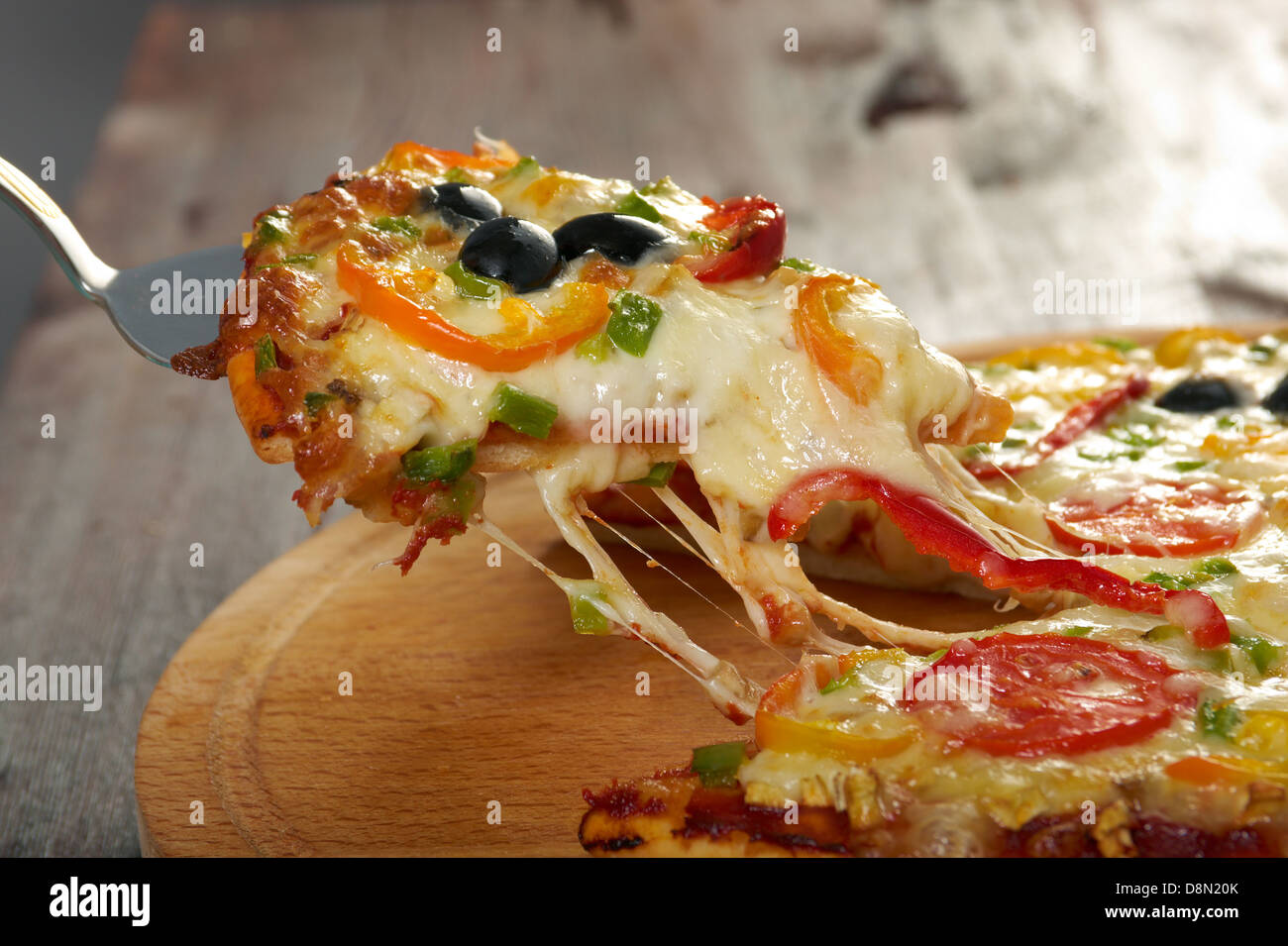 taking slice of pizza,melted cheese dripping Stock Photo - Alamy