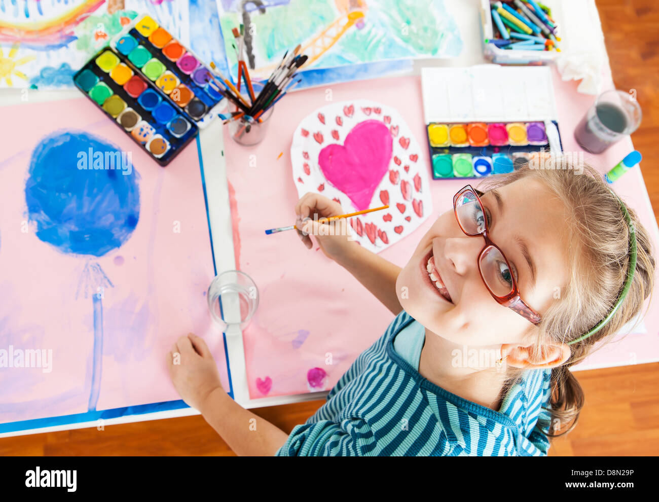 Schoolgirl painting with water color - top view Stock Photo - Alamy