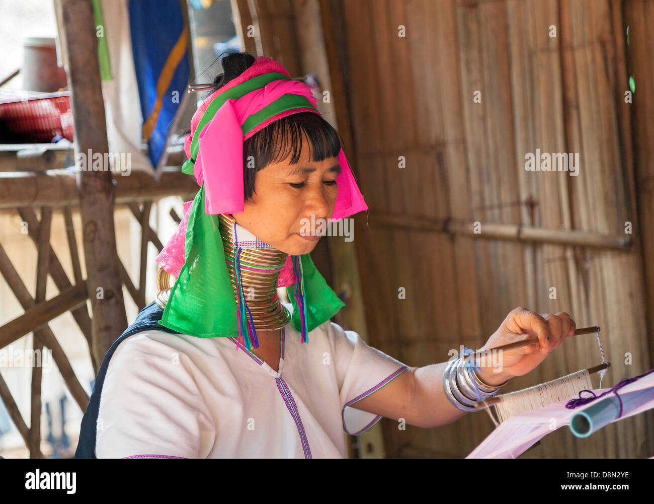 Karen Padong tribeswoman, a Burmese refugee from Myanmar, weaving in a ...